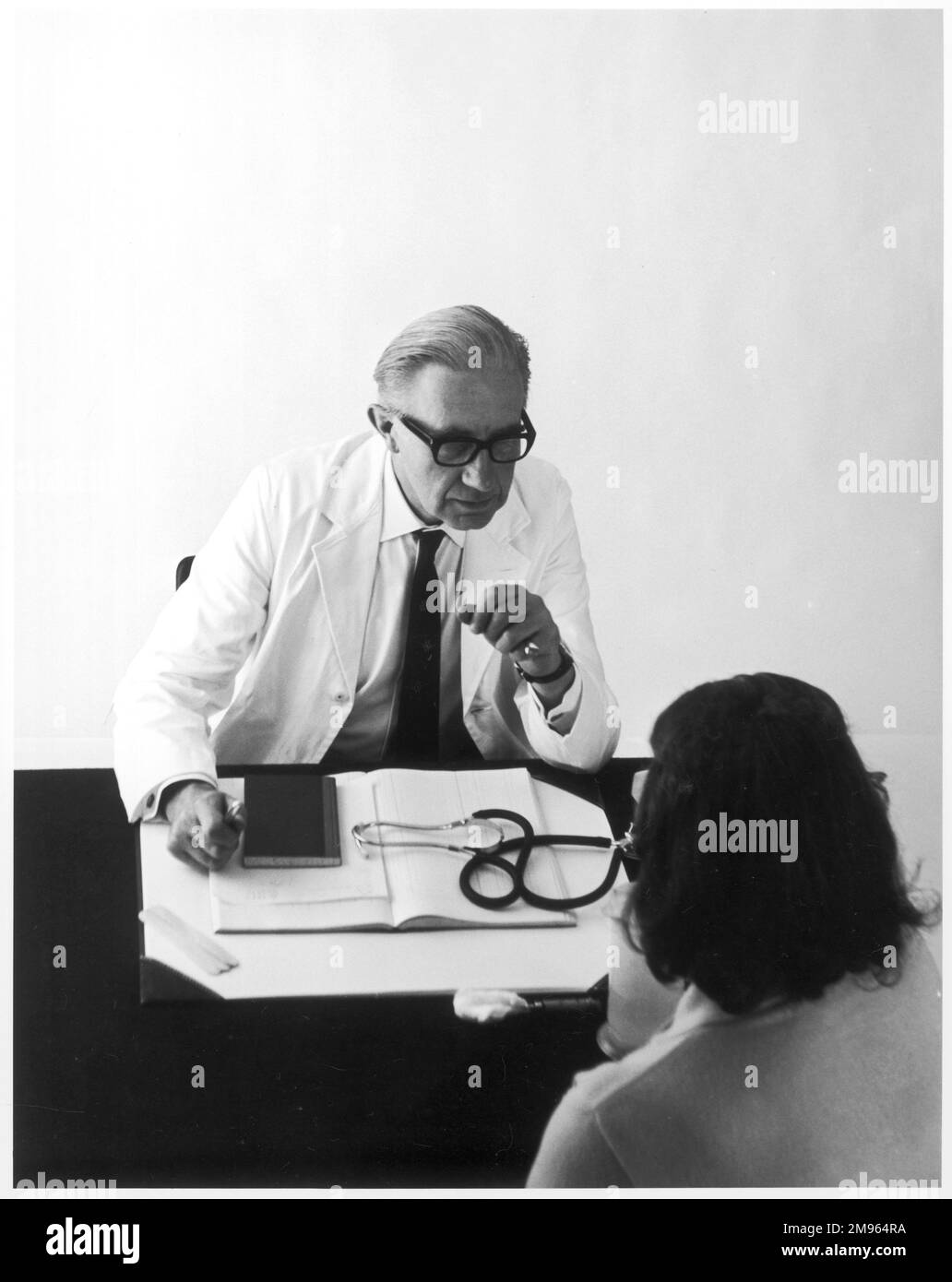 1960s doctor at desk hi-res stock photography and images - Alamy