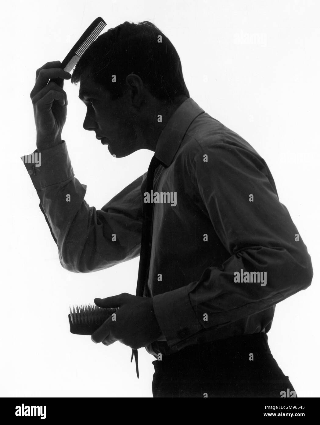 Profile of a man combing his hair Stock Photo - Alamy