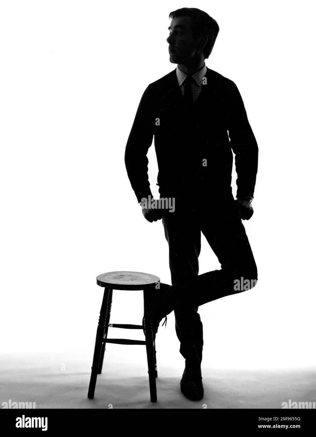 A young man poses with a stool Stock Photo - Alamy