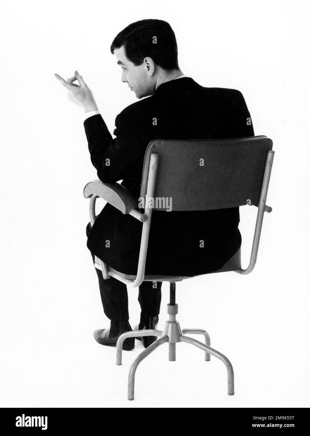 A man poses on a swivel chair Stock Photo - Alamy