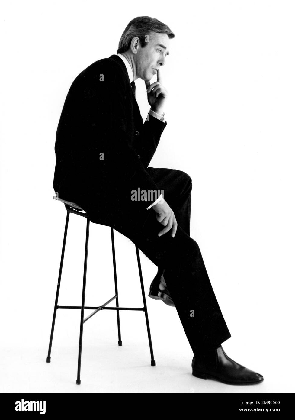 On a stool Black and White Stock Photos & Images - Alamy