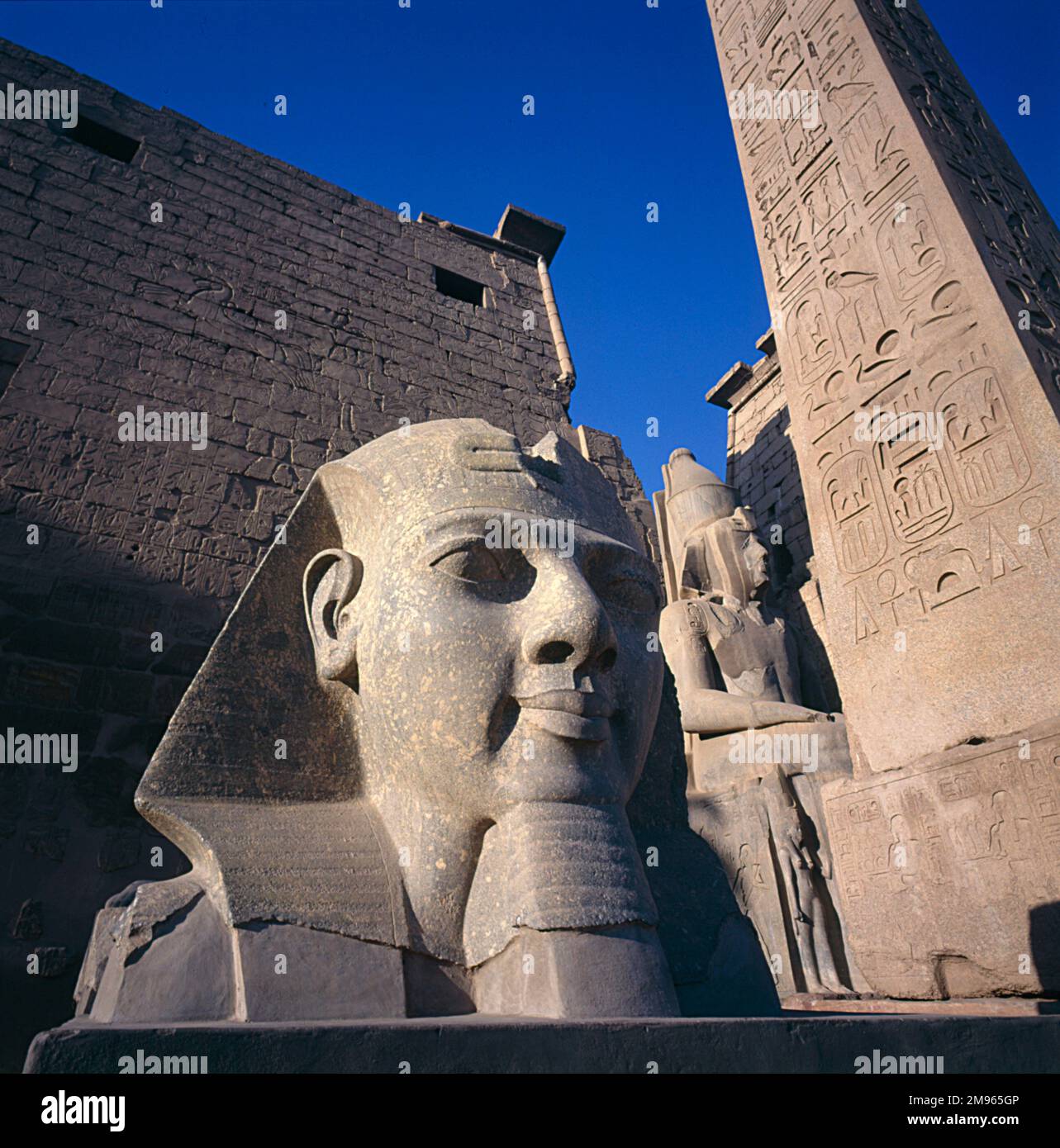 Giant head (probably depicting RAMESES II )beside the Obelisk in front ...