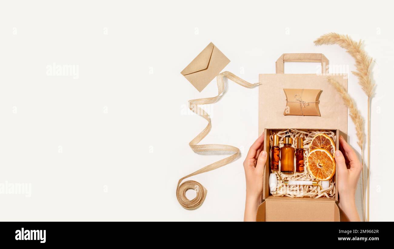 Female hands hold cardboard gift box with self care set with natural ...