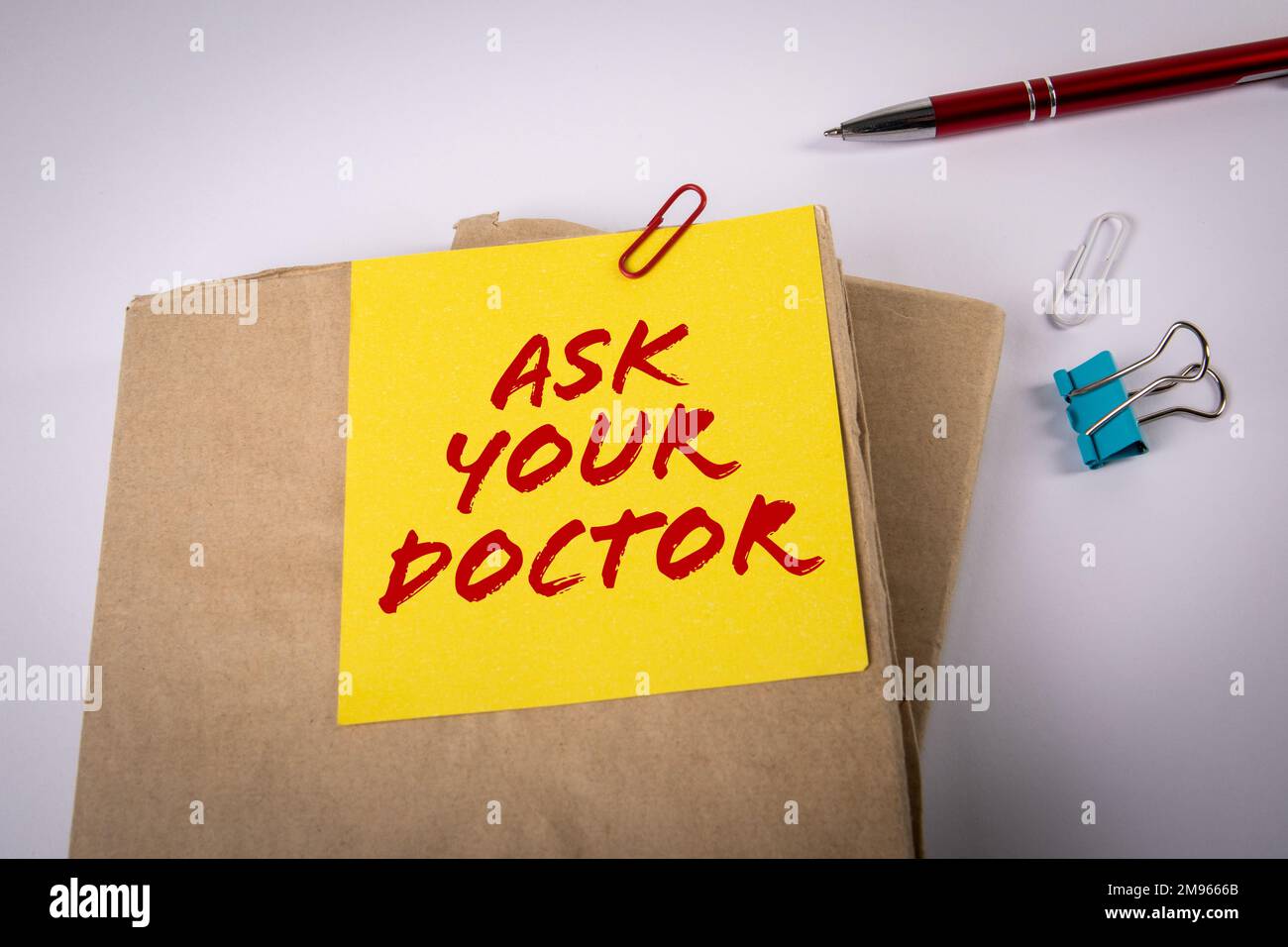Ask Your Doctor. Yellow sticky note with text on book Stock Photo - Alamy