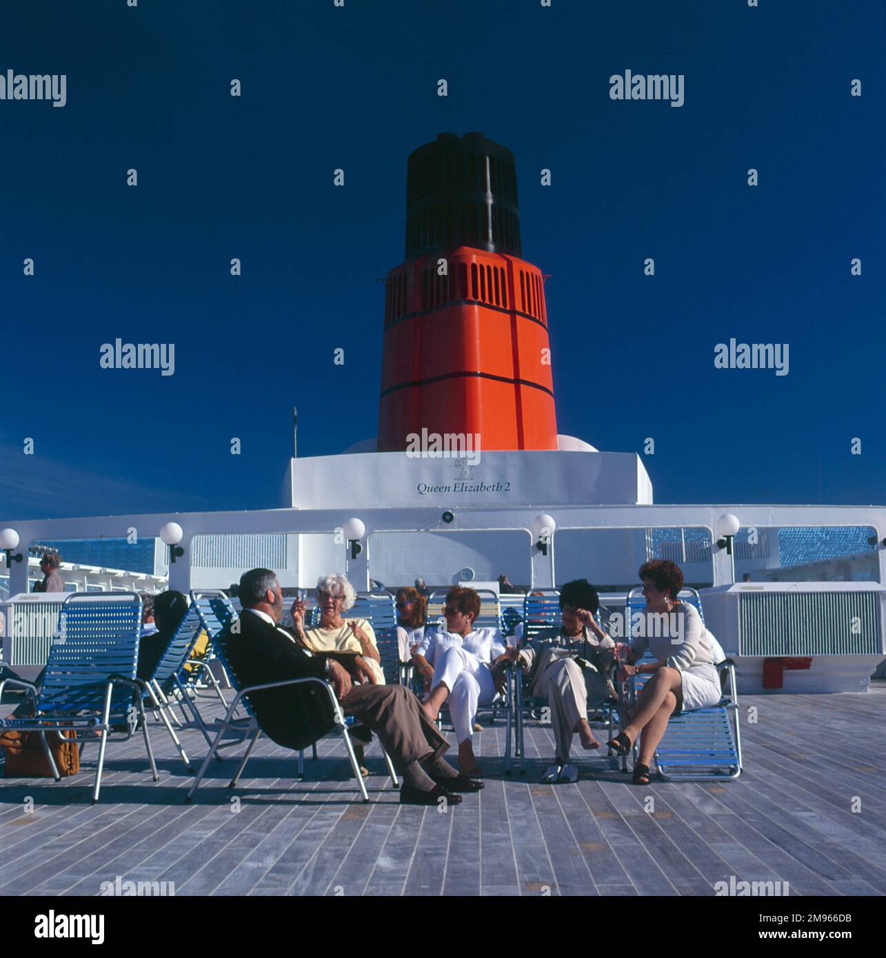 Passengers relaxing on the sun deck of the liner Queen Elizabeth II ...