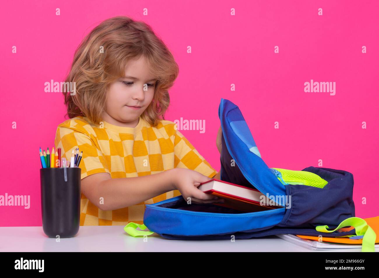 Back to school. Funny little child from elementary school puts school ...
