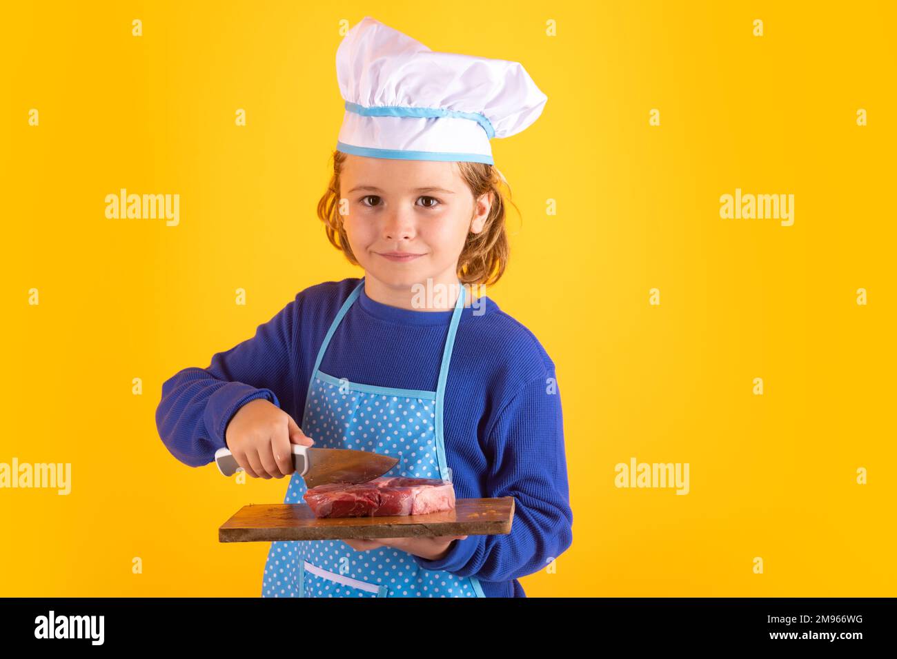 Kid cook hold cutting board with meat beef steak and knife. Kid in ...