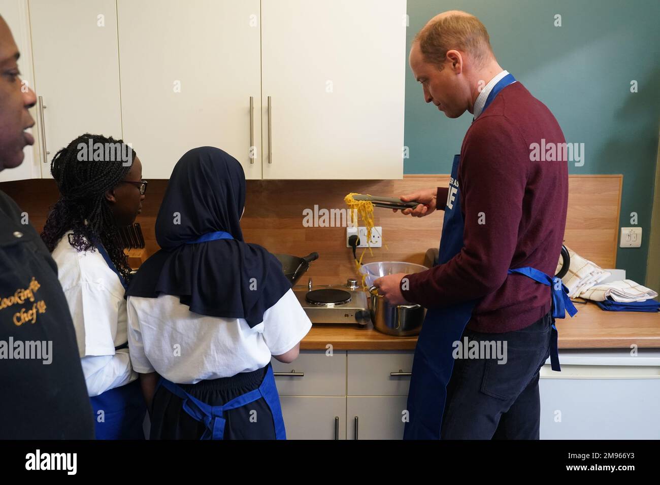 The Prince of Wales takes part in a cooking lesson during his visit to ...
