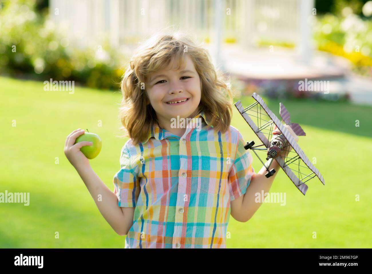Child in the village with plane in his hands. Child boy toddler playing ...
