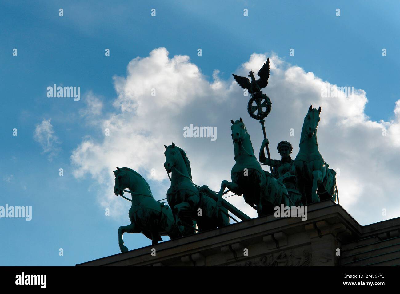The Quadriga (four horses drawing a chariot), seen here in silhouette ...