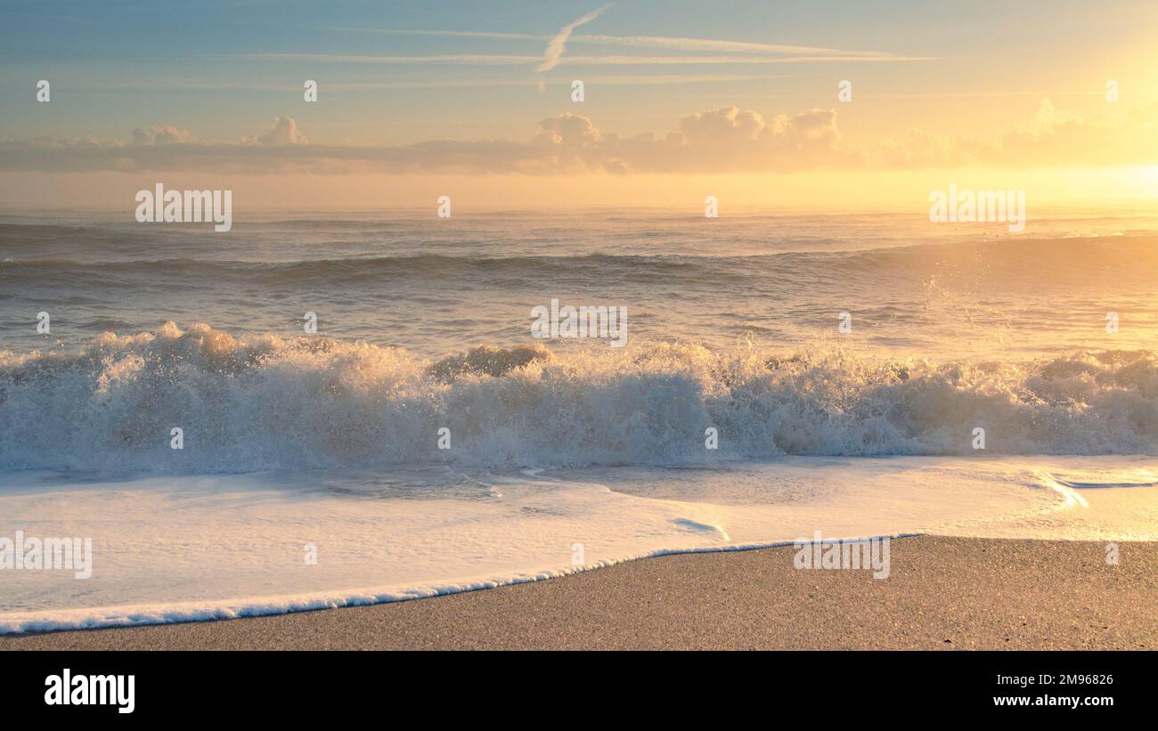 Sunrise misty beach Stock Photo - Alamy