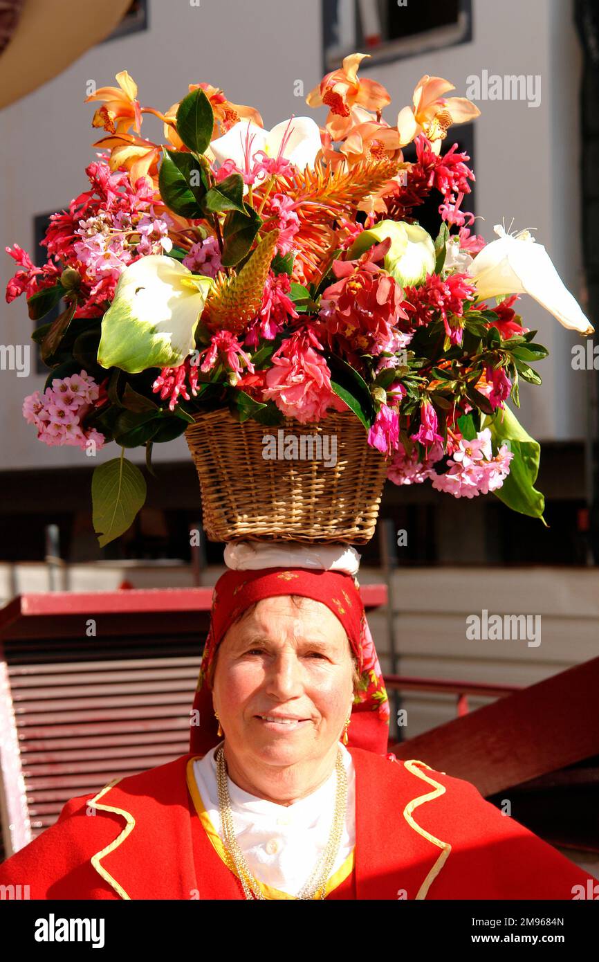 A woman from a folklore group from the village of Camacha, walking ...