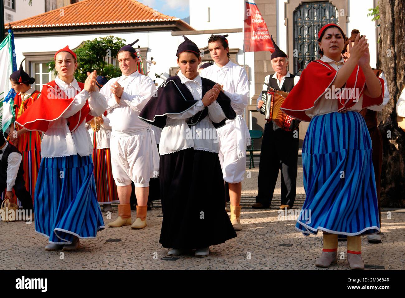 A folklore group from the village of Camacha, dancing in the street in ...