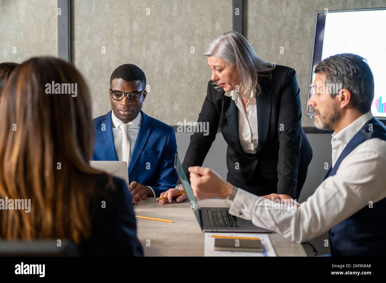 Multiracial business team working together, senior female boss ...