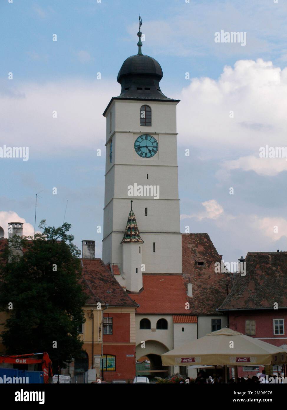 View of the white clock tower on the small square (Piata Mica) in Sibiu ...