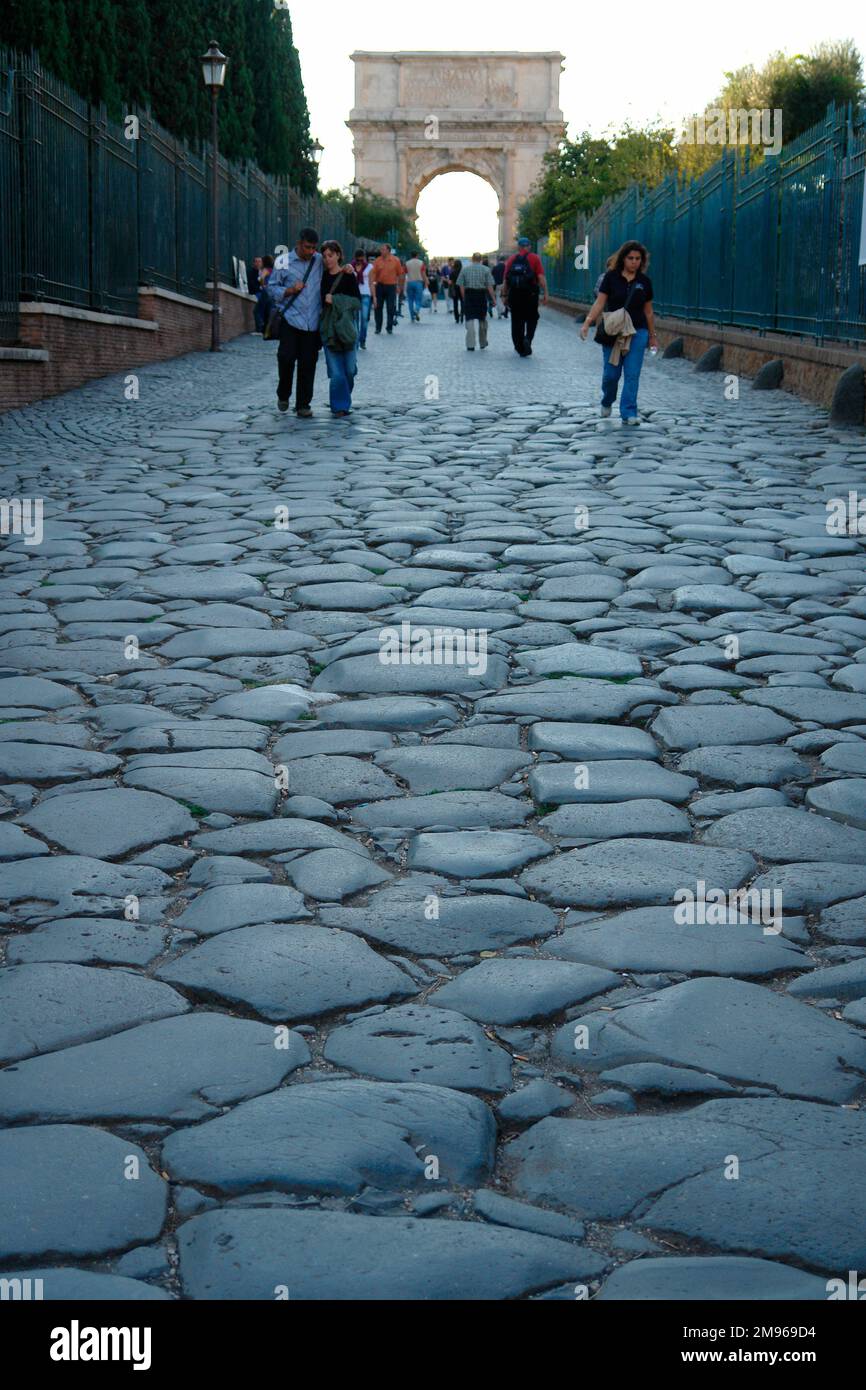 A cobbled Roman road leading to the Forum Romanum, with the Arch of ...