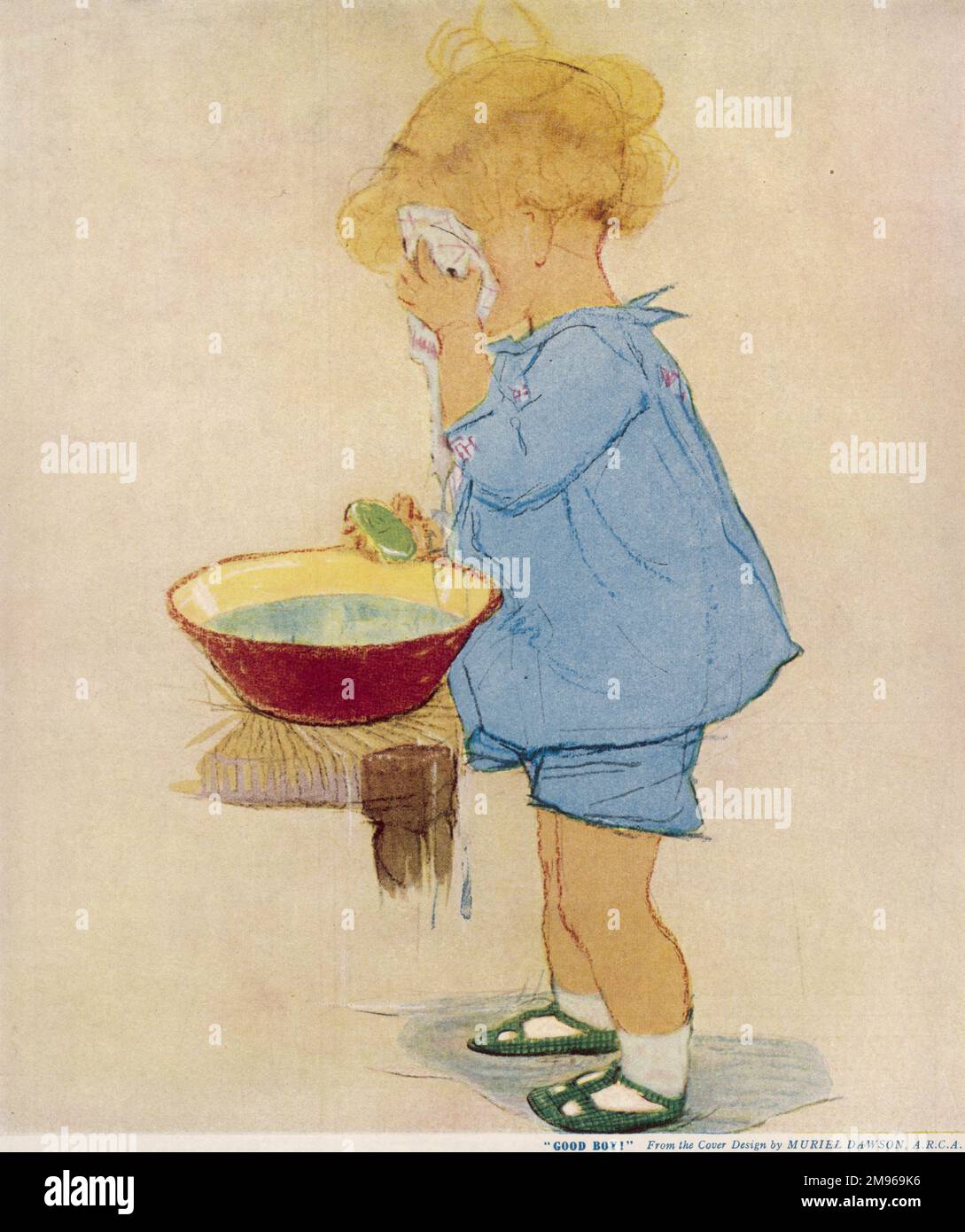 A little boy in a charming blue smock and shorts outfit, washes his ...