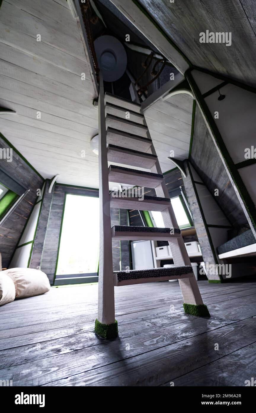White vertical wooden stairs to the second floor from living room of ...