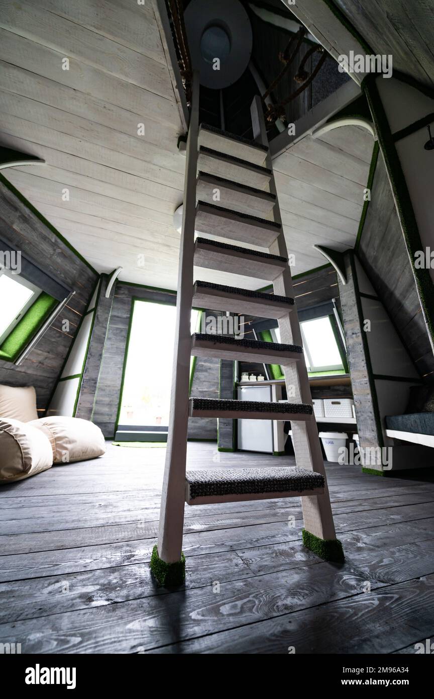 White vertical wooden stairs to the second floor from living room of ...