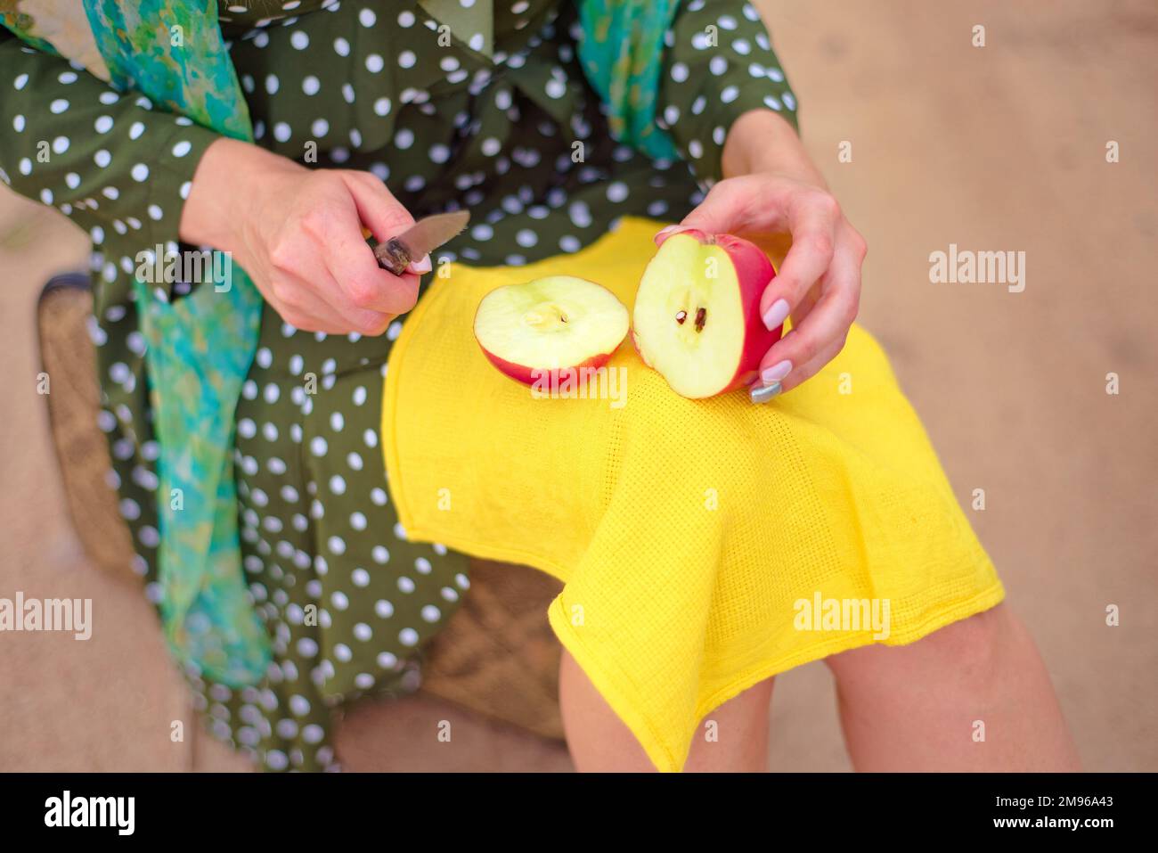 Beautiful girl on a trip eating an apple sitting on a suitcase n the ...