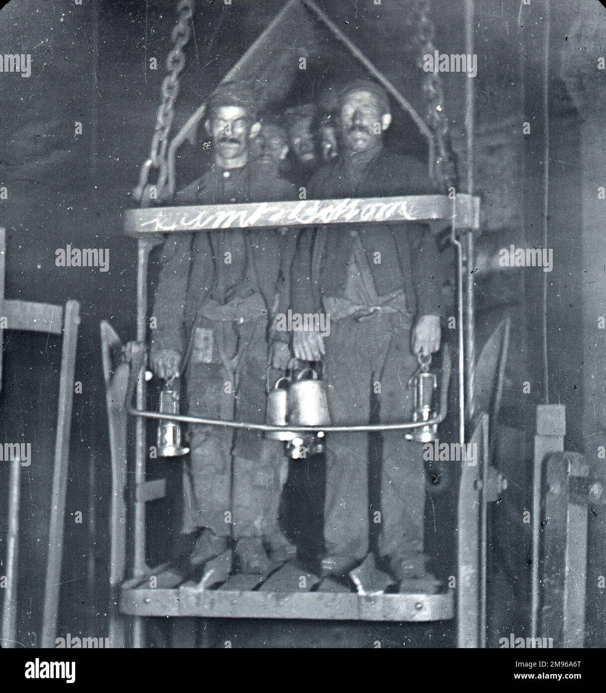 Several coal miners with blackened faces stand in the shaft lift at the ...