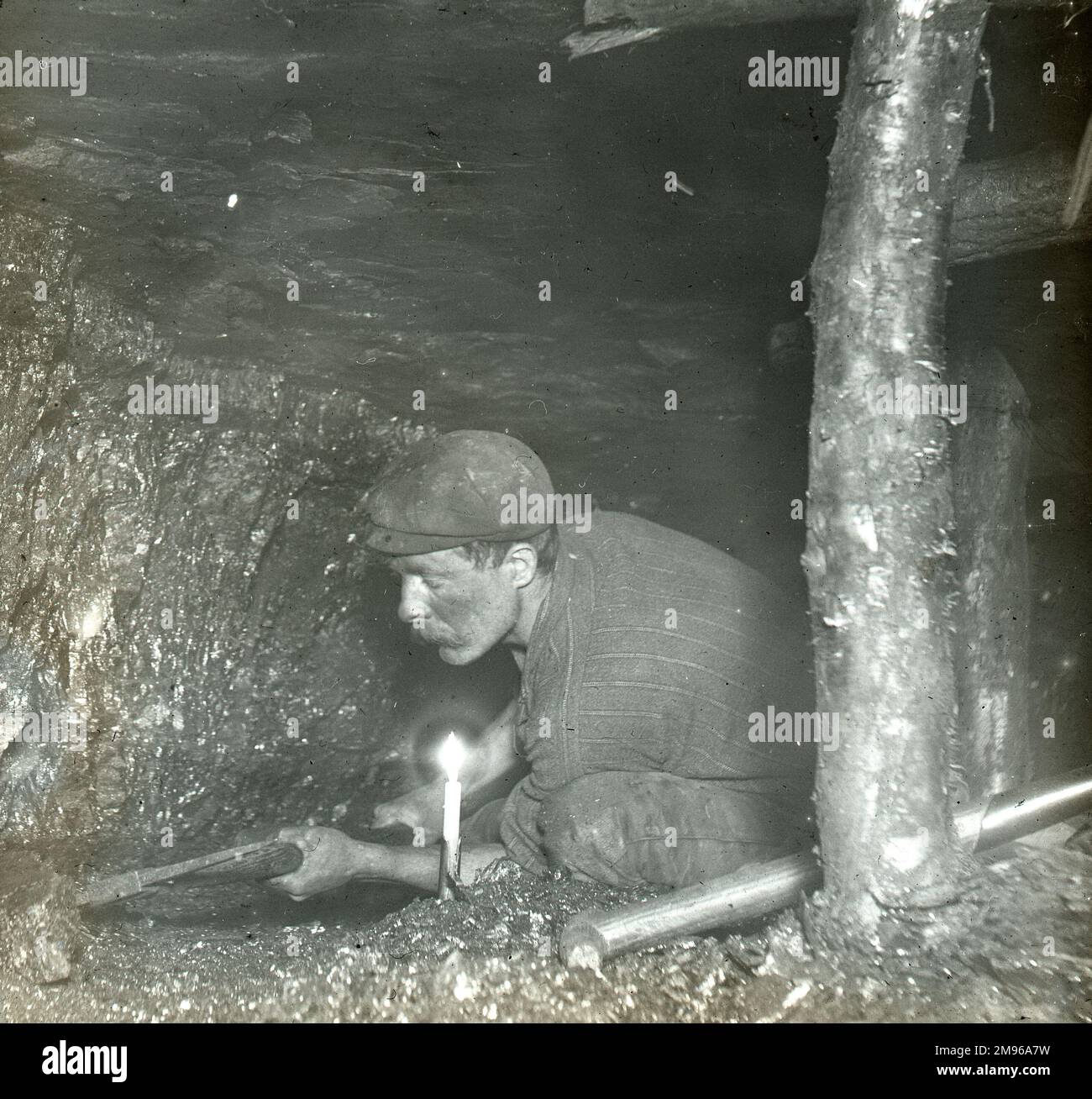 A miner undercutting or holing the coal in a narrow seam, Plas y Coed ...