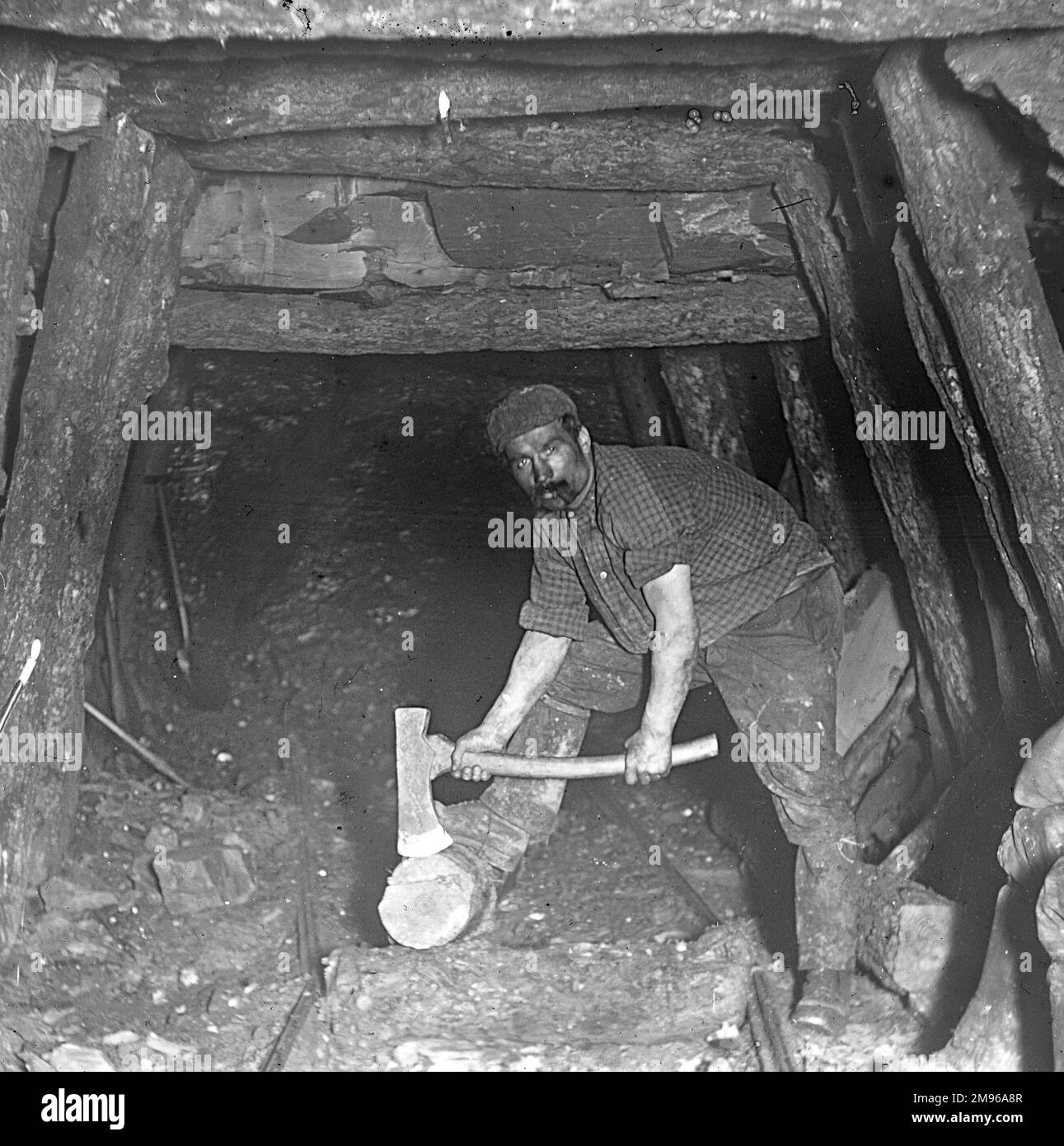 A miner repairing pit props in the Plas y Coed Level, South Wales. Date ...