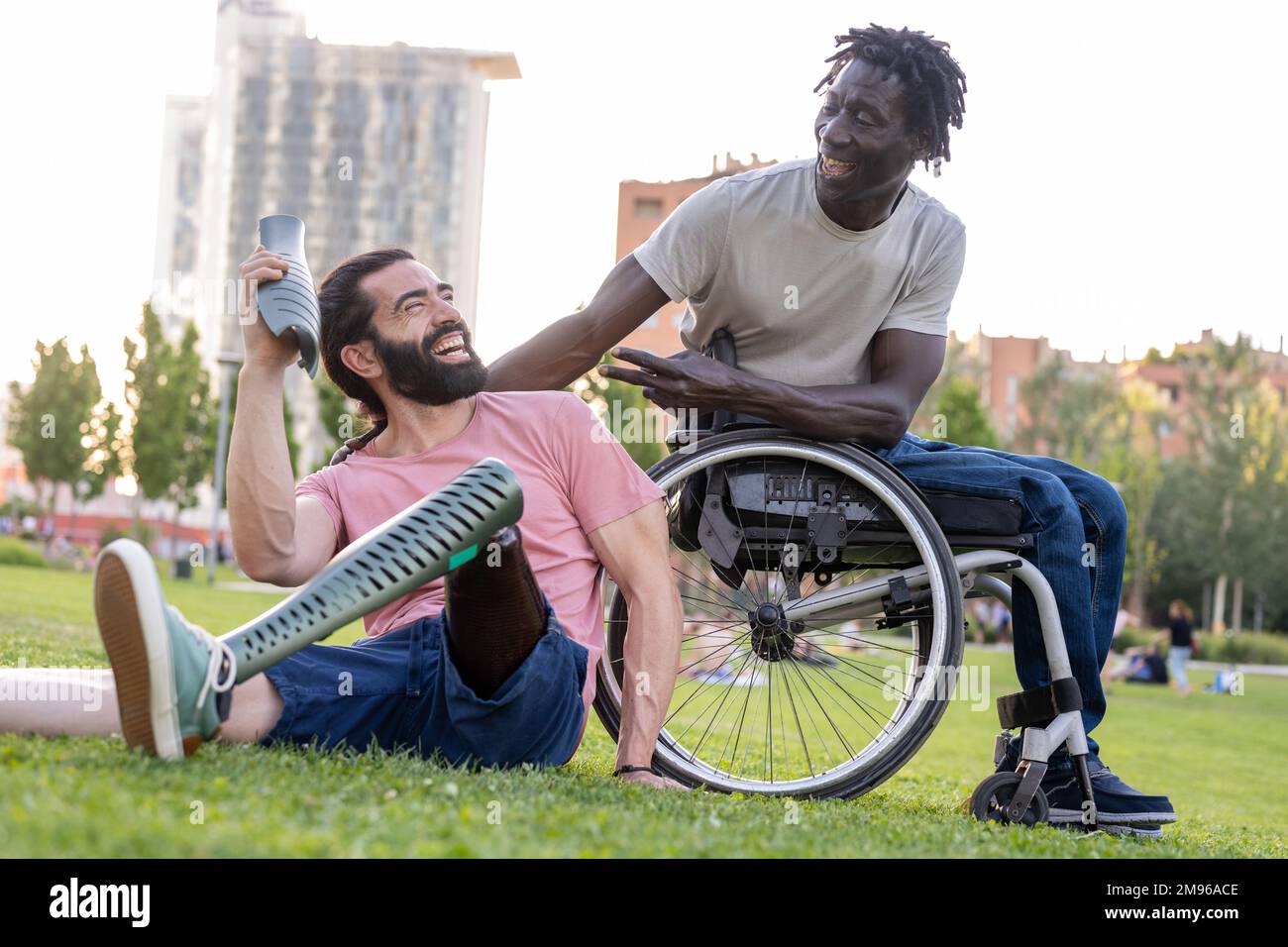 two multiracial friends with disabilities joking and laughing, people ...