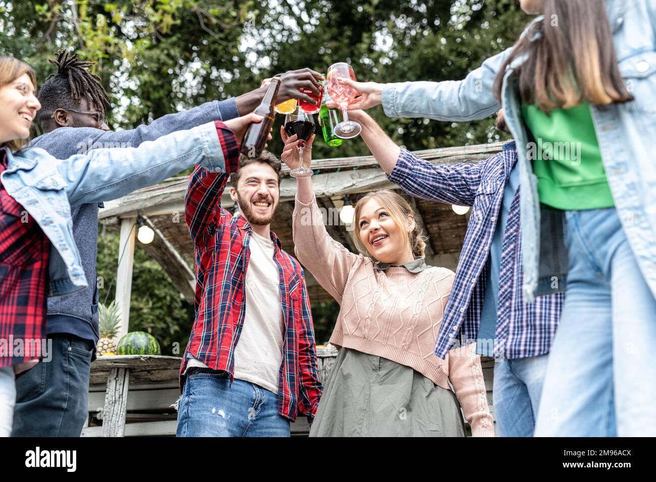 Happy multiracial people having fun at family party on the rooftop ...