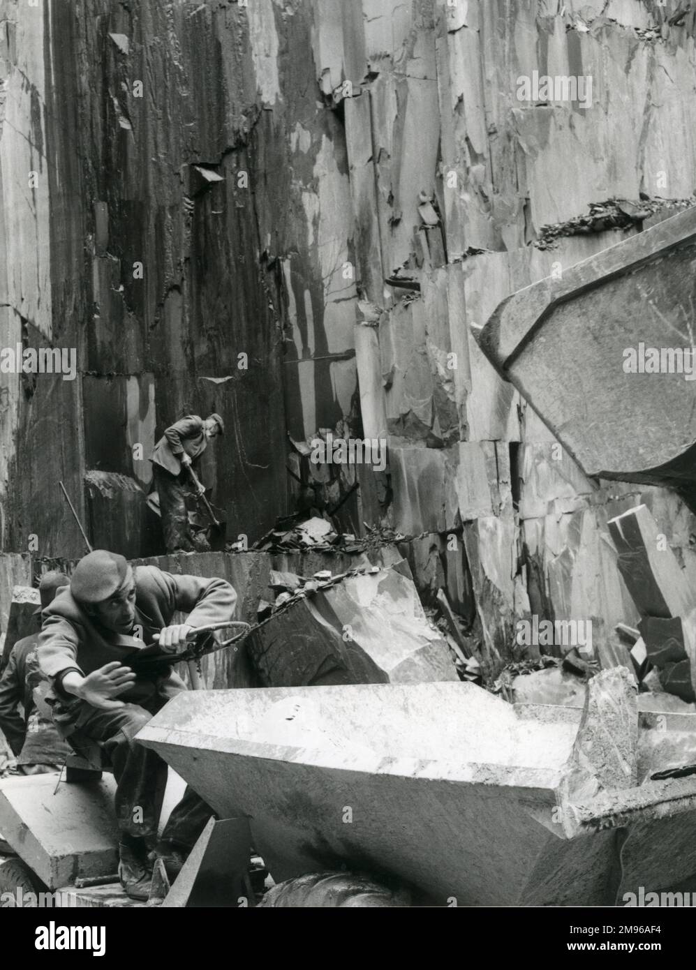 A workman moving slate waste at Penyrorsedd Slate Quarry, Nantlle ...