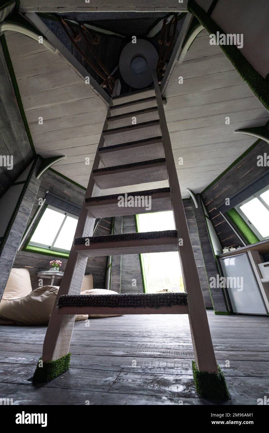 White vertical wooden stairs to the second floor from living room of ...
