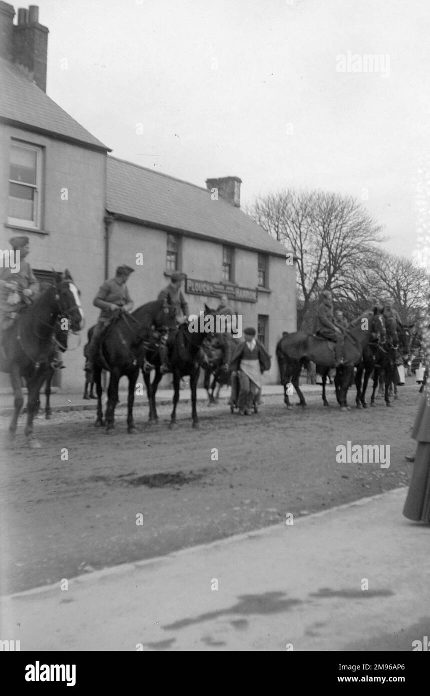 A cavalry parade pauses outside the Plough and Harrow pub in ...