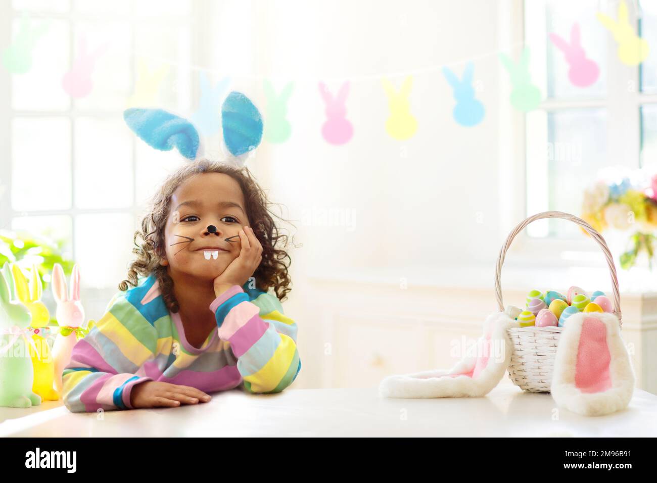Kids dyeing Easter eggs. Children in bunny ears dye colorful egg for ...