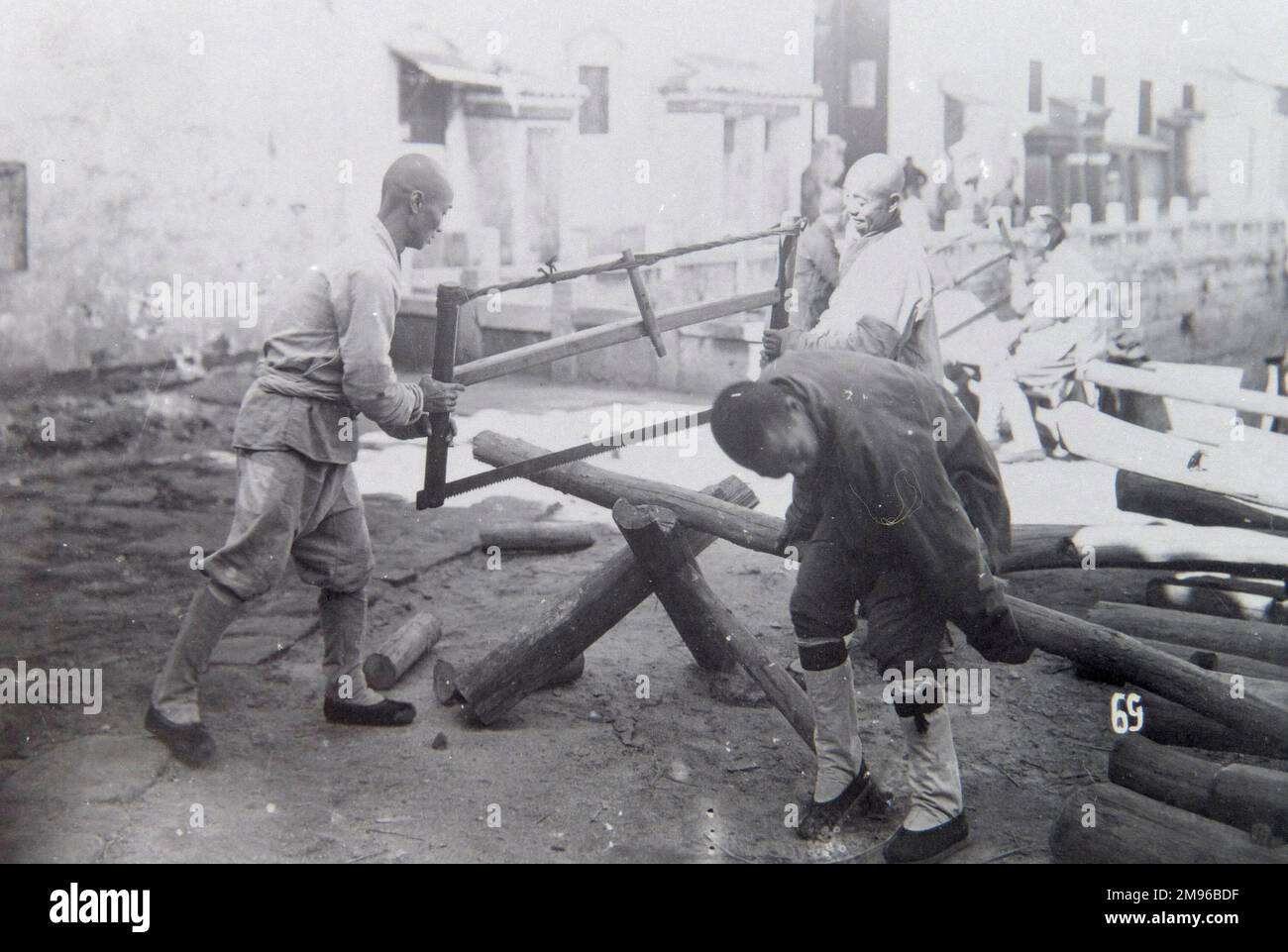 A group of loggers at work with a rectangular saw, somewhere in the Far ...