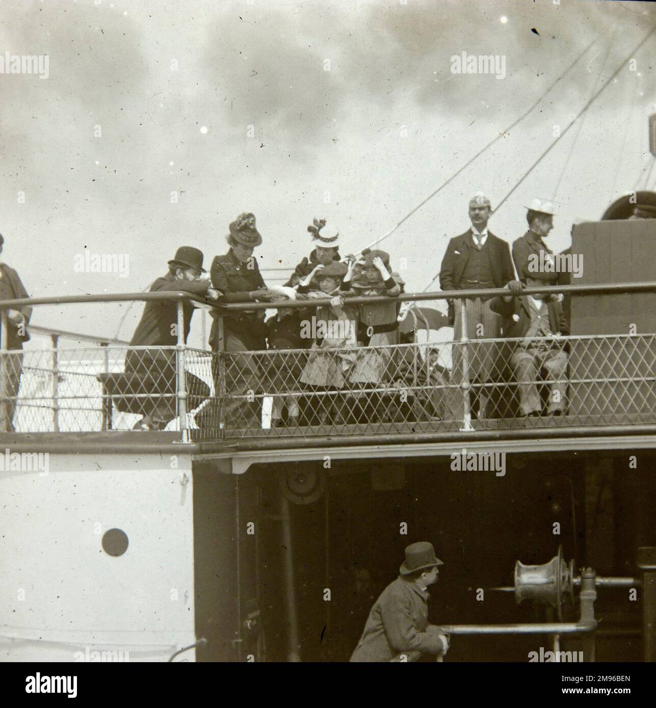 A group of Edwardian passengers, adults and children, on board a ...