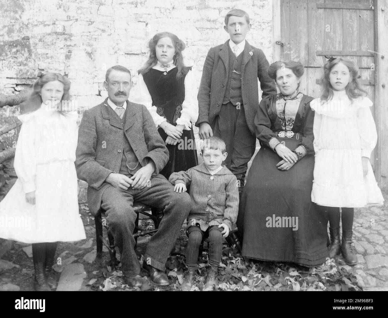 An Edwardian family (parents and five children) pose for a group ...