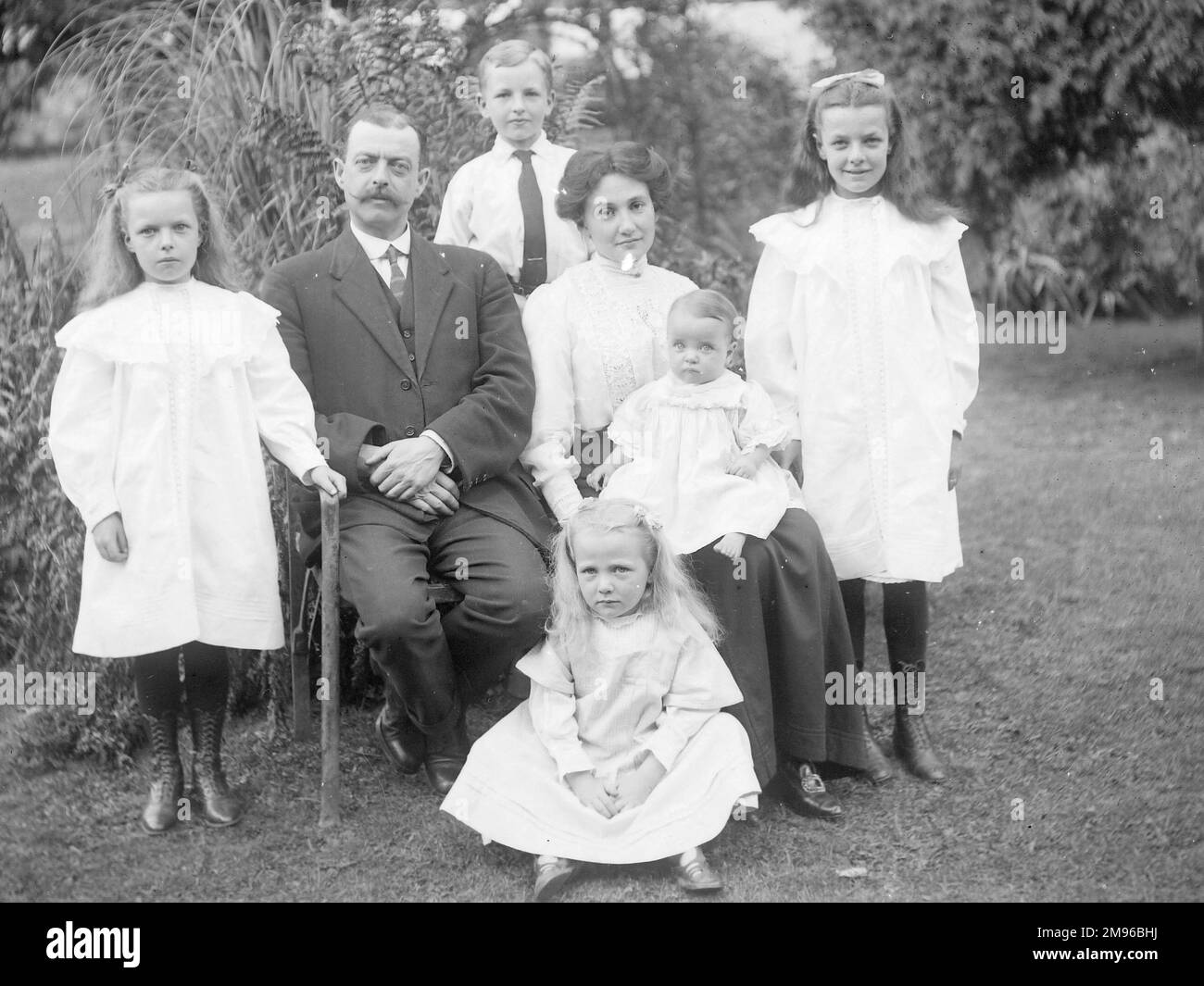 A middle class family (parents and five children) pose for their photo ...