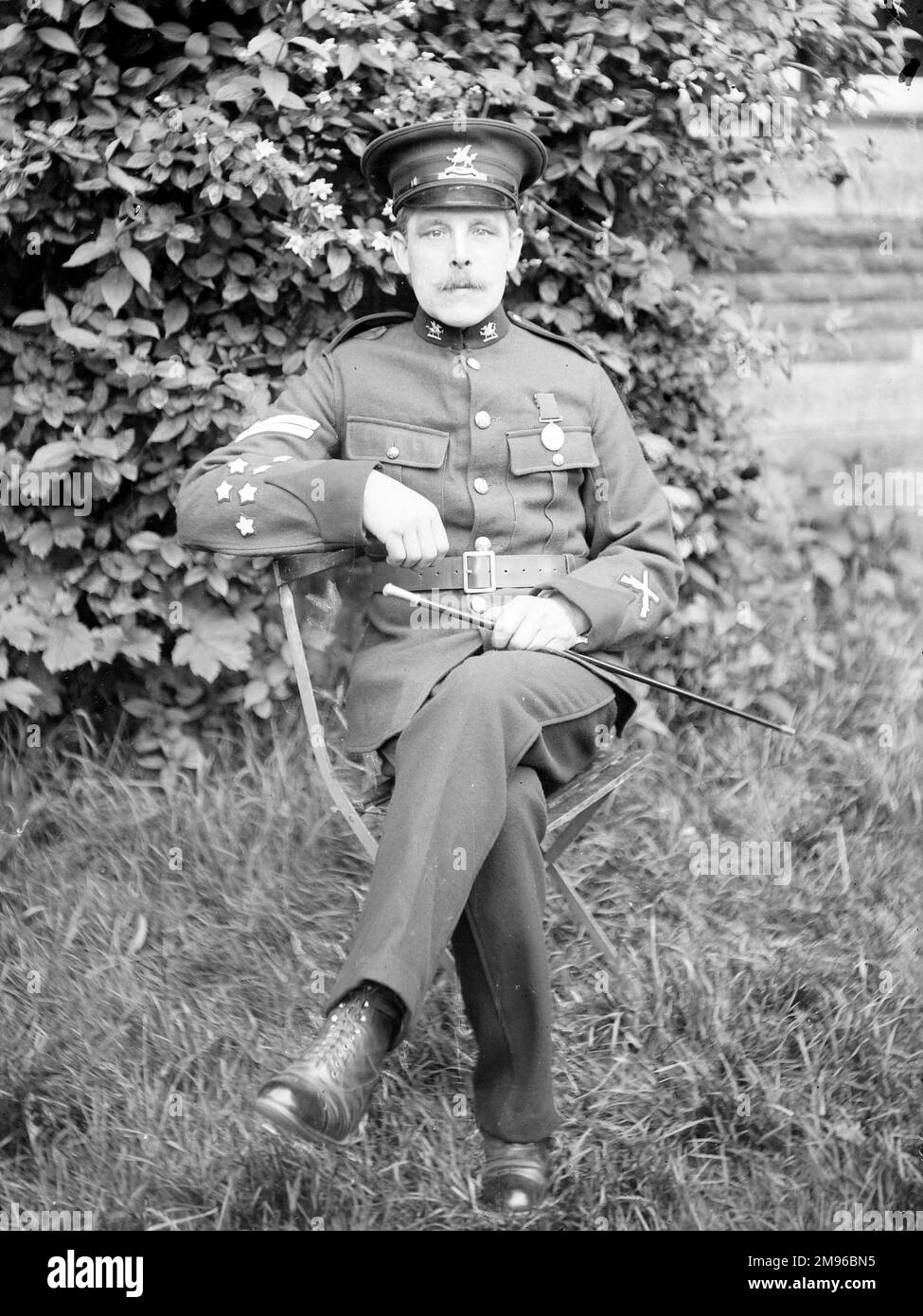 Portrait of an army corporal in full uniform, posing for his photo in a ...