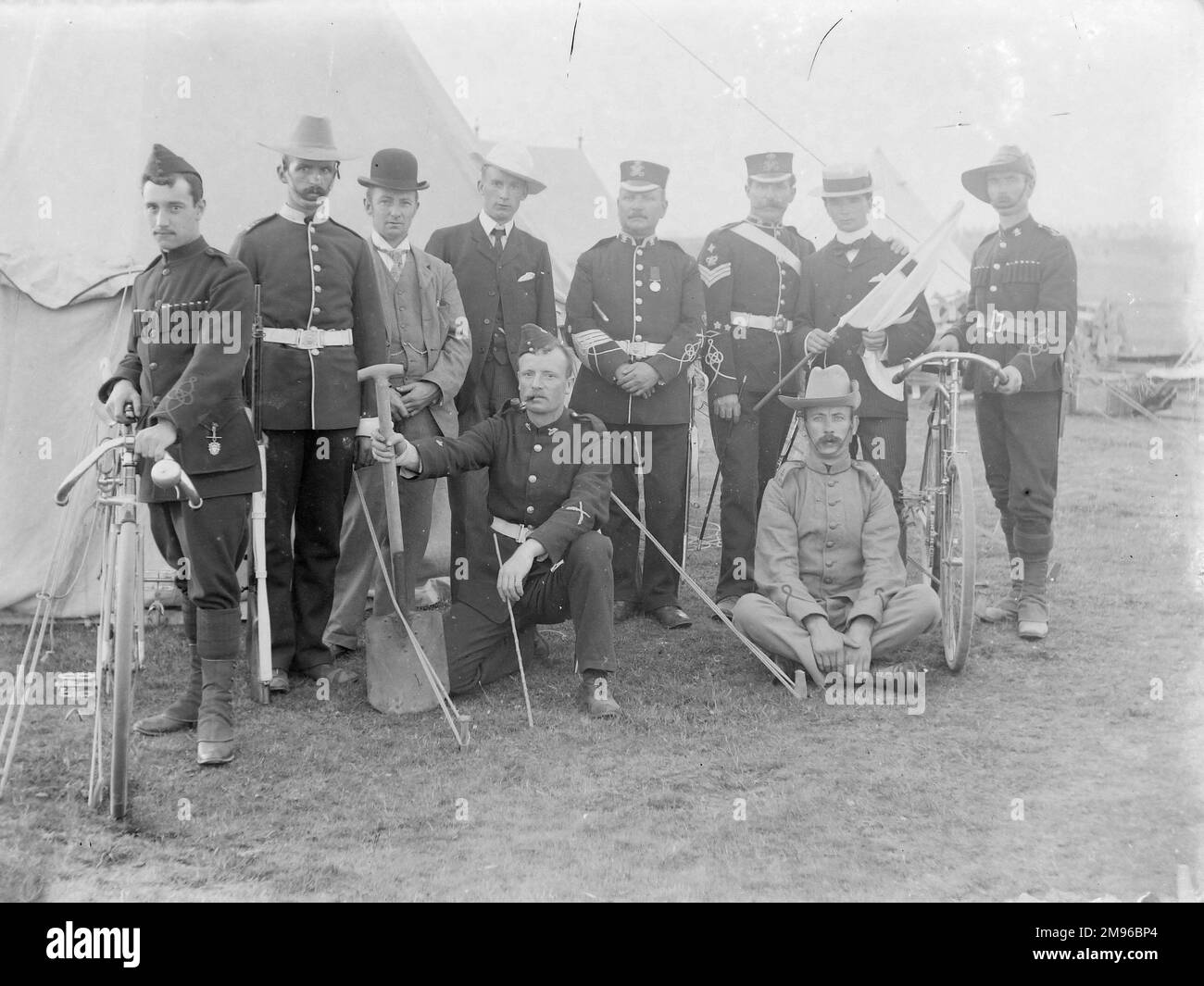 A group of soldiers and civilians at a training camp, posing for their ...