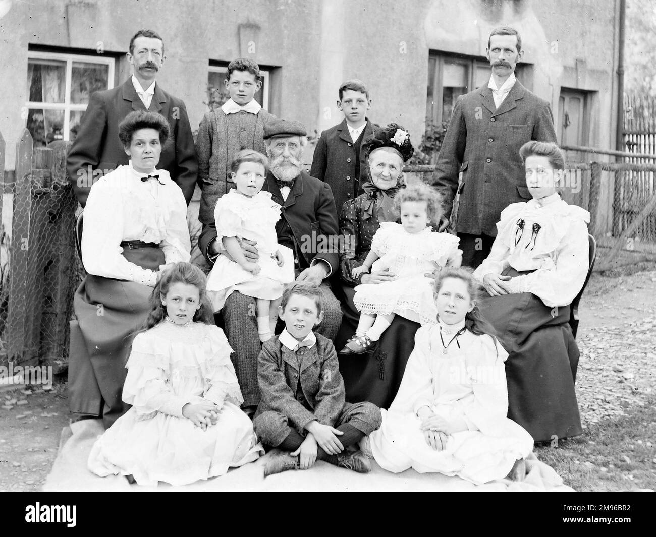 A family group of thirteen, covering three generations, with the ...