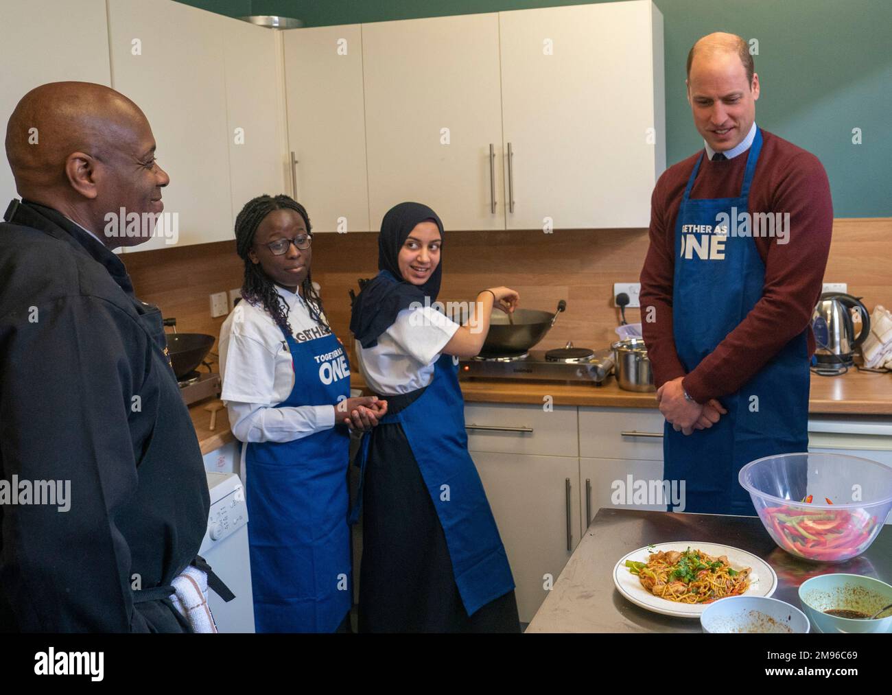The Prince of Wales takes part in a cooking lesson with Daisha Nagawagi 12, Inaaya Shahab 13 and ...