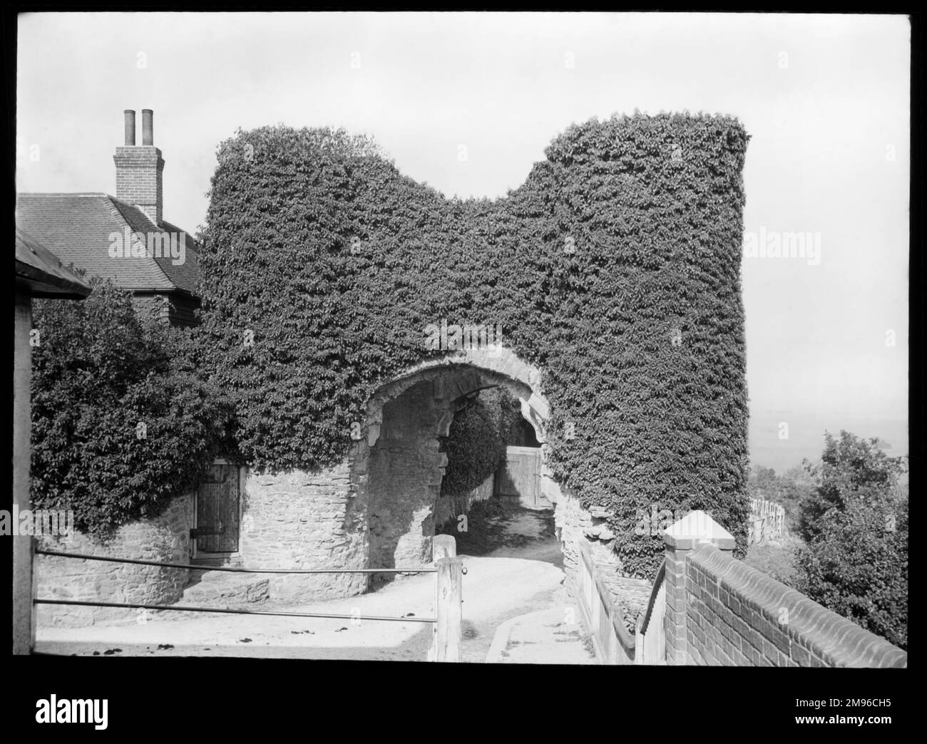 An old stone archway overgrown with leaves Stock Photo - Alamy