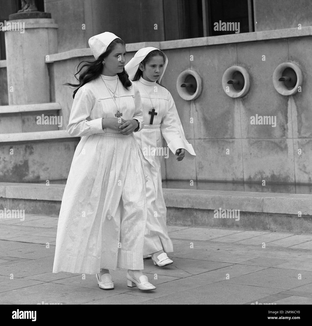 Two girls dressed in white, possibly for their first communion Stock ...