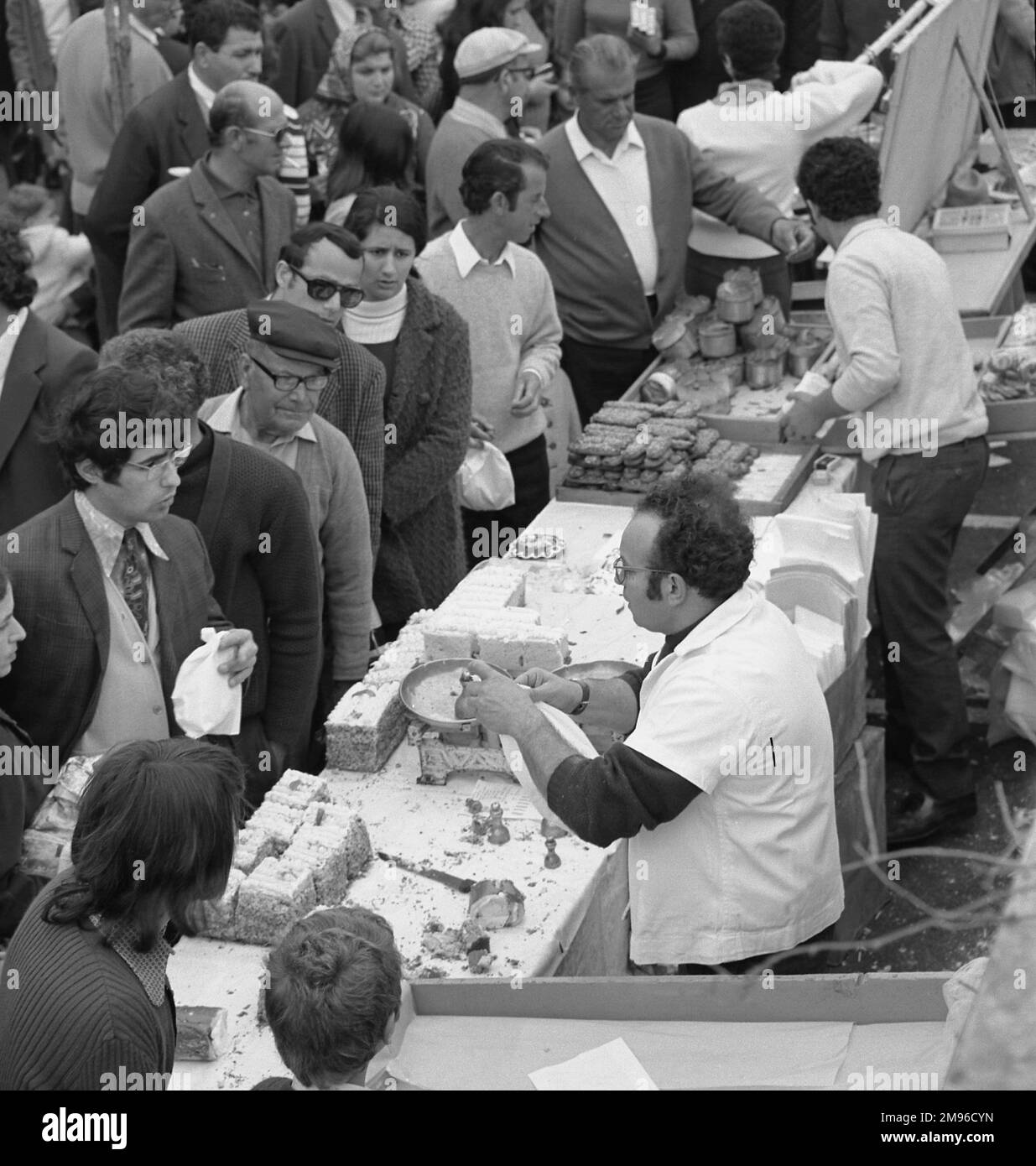 People buying and selling cakes at an open air food market Stock Photo ...