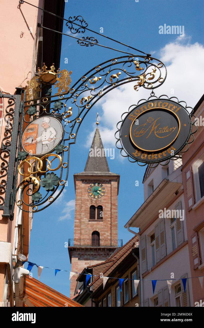 View of an old bakery sign and clock tower in the town of Eberbach ...