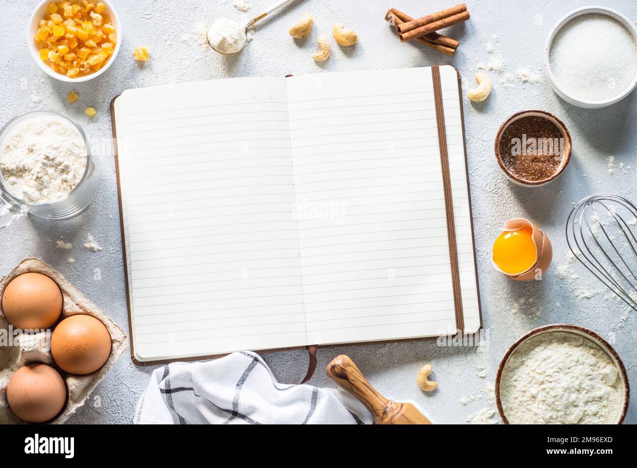 Baking background with cooking book and ingredients. Flour, sugar, eggs ...