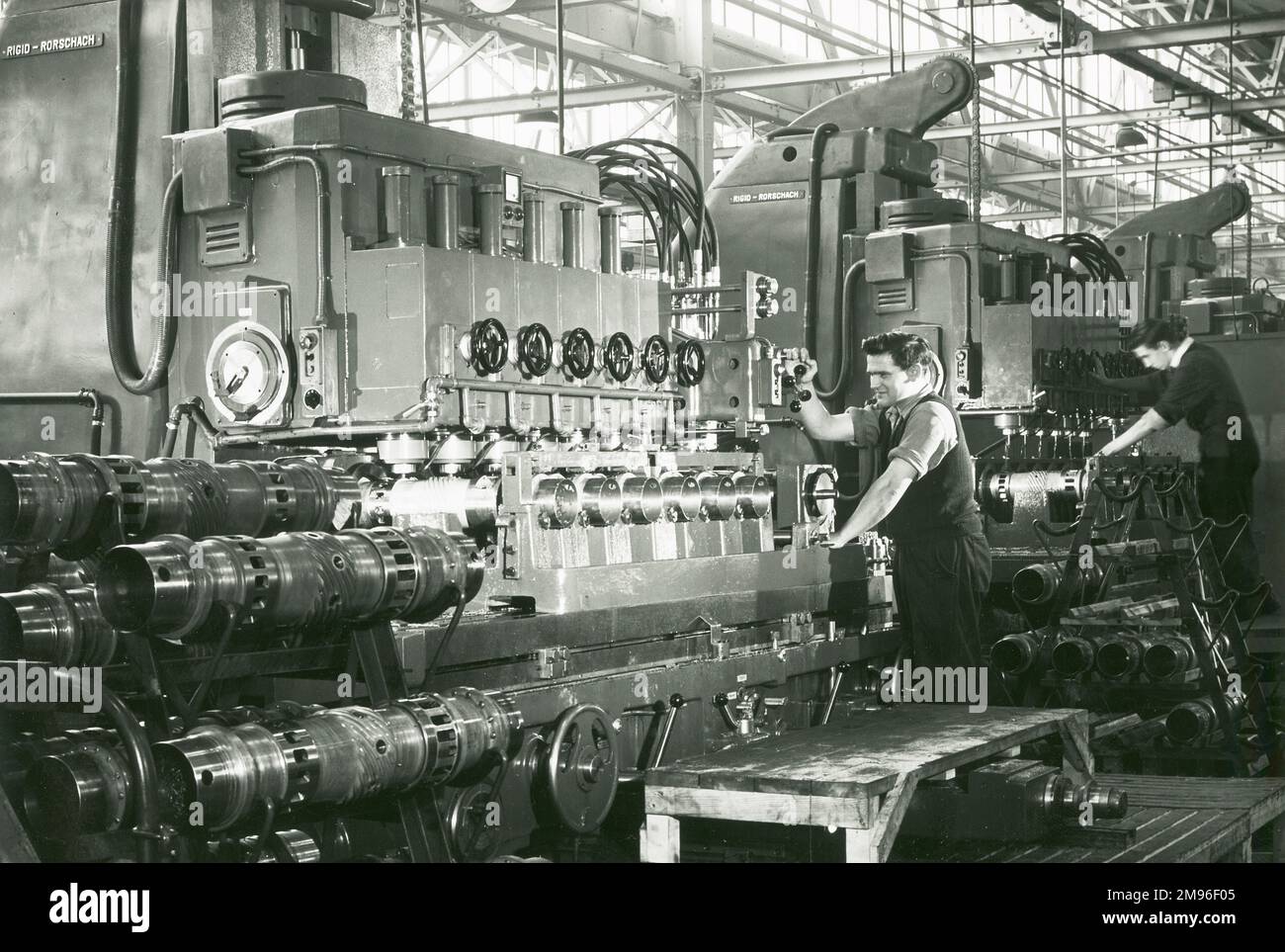 Liverpool Works, two men operating Deltic sleeve port-milling machinery ...