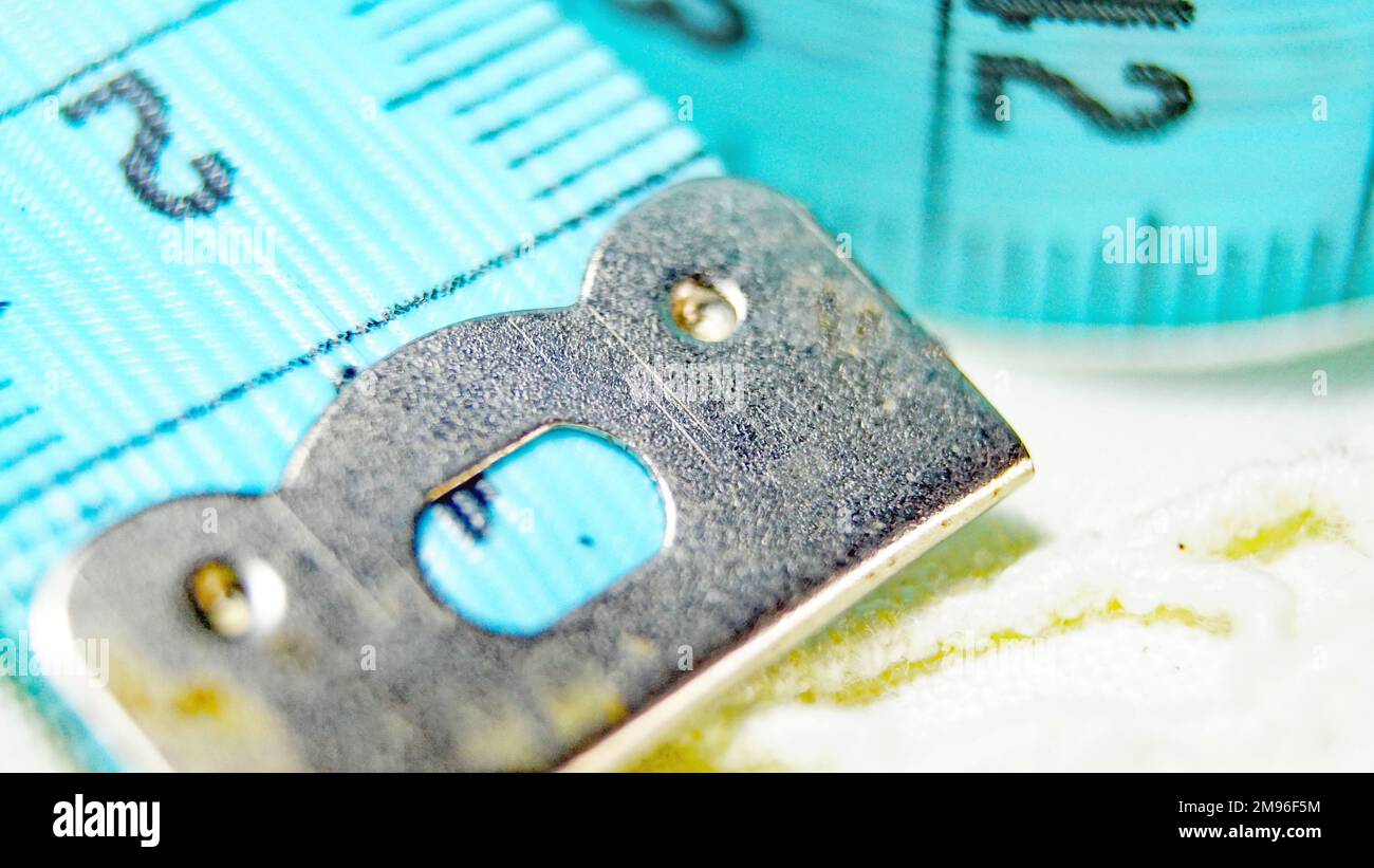 Sewing blue meter on white background Stock Photo - Alamy