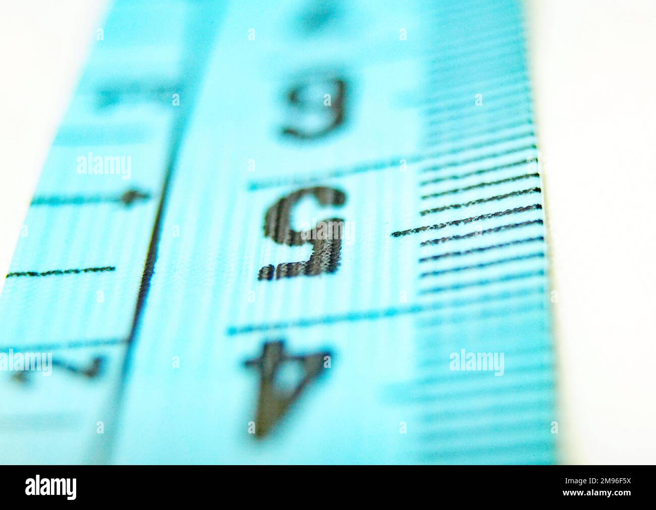 Sewing blue meter on white background Stock Photo - Alamy