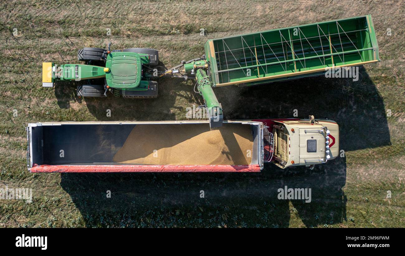 An aerial view of a tractor offloading wheat to truck Stock Photo - Alamy